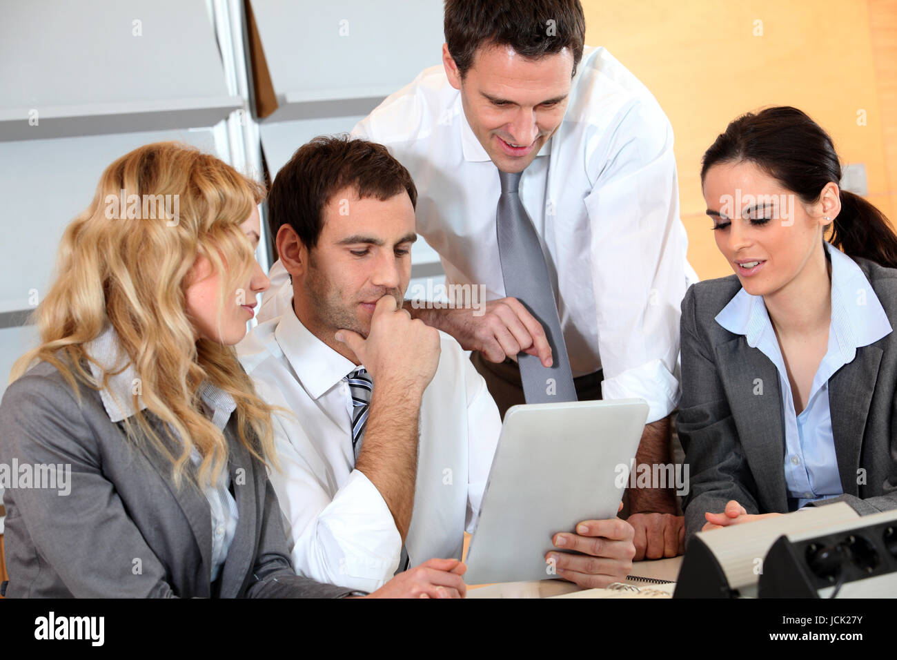 Group of business people meeting around table Stock Photo - Alamy