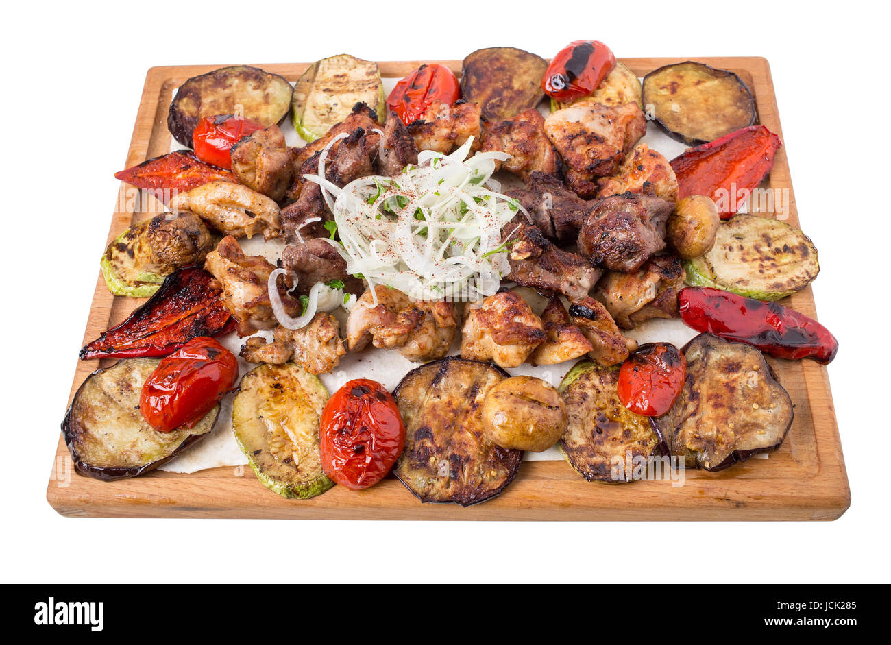 Mixed grilled meats platter with vegetables. Isolated on a white ...