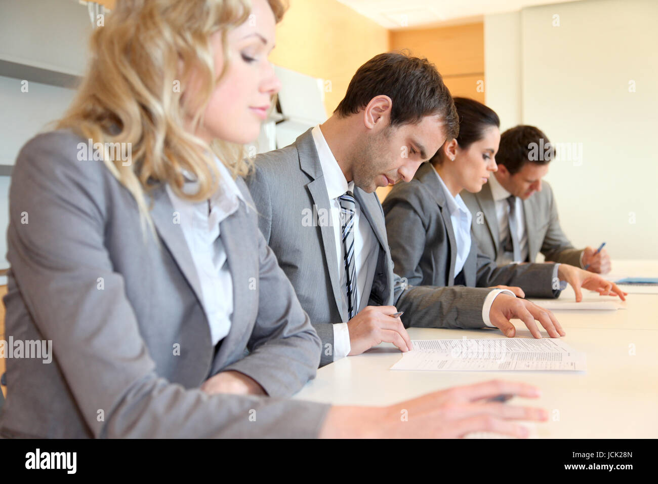 Young business people signing application form Stock Photo - Alamy