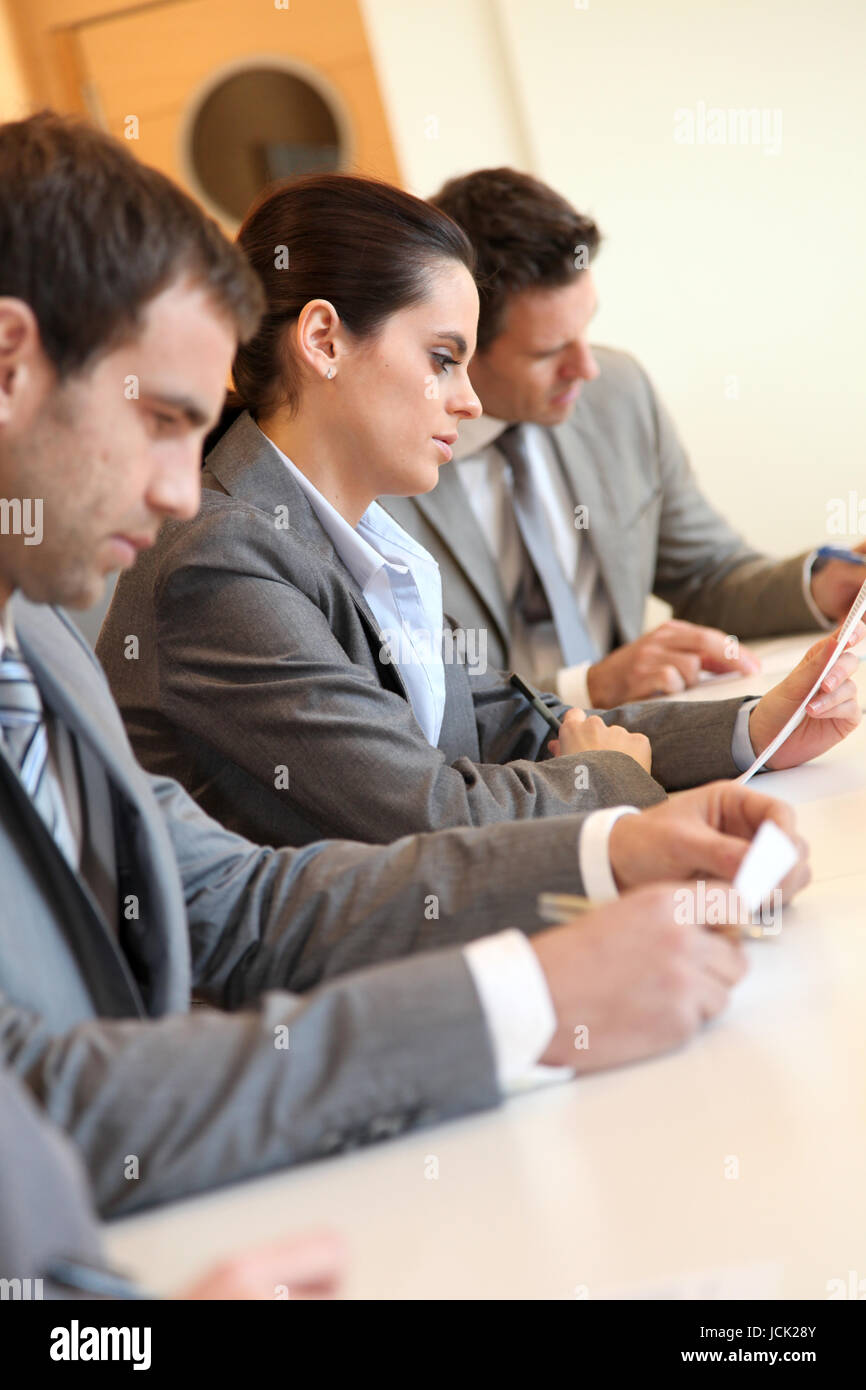 Young business people signing application form Stock Photo - Alamy
