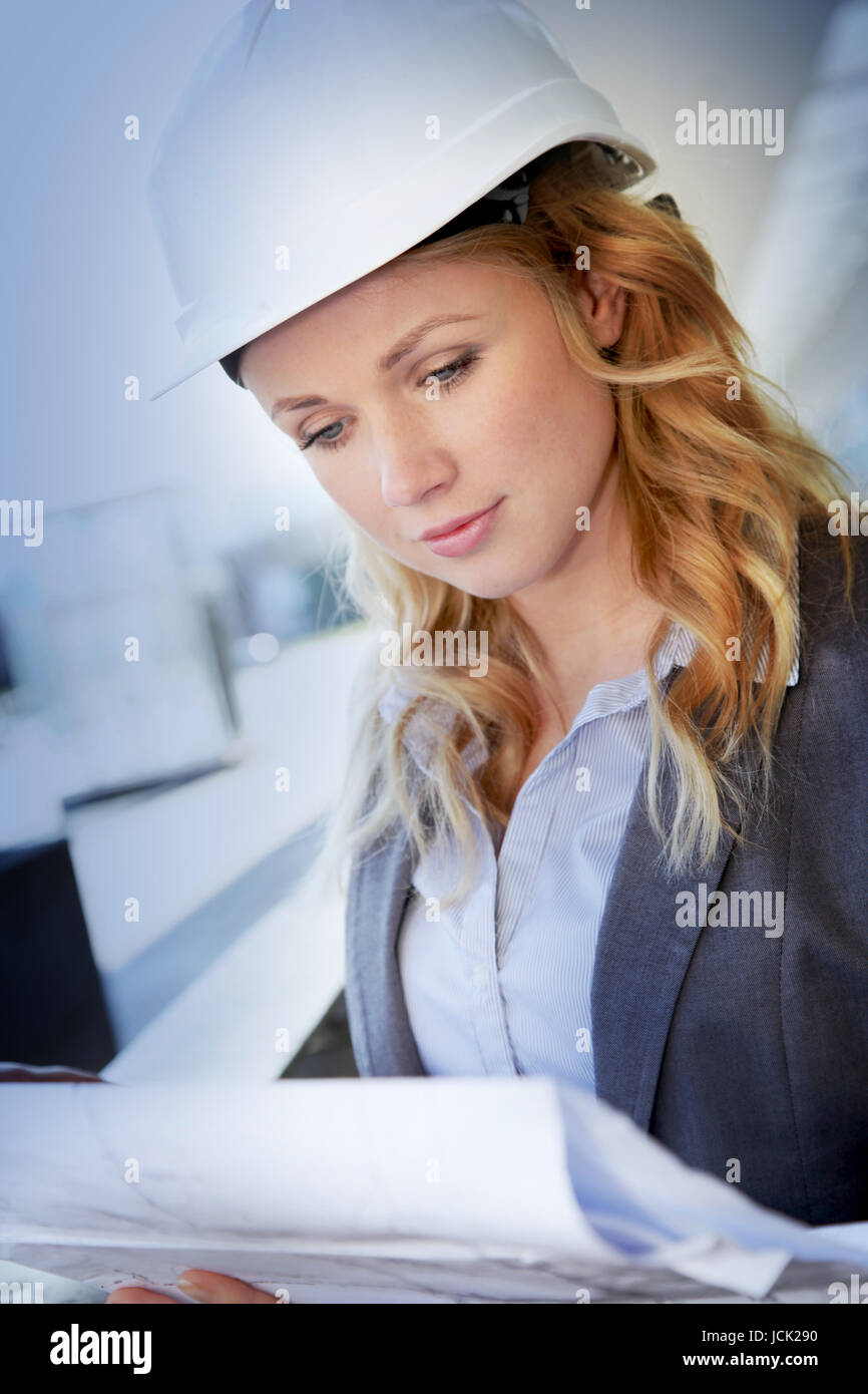 Portrait of beautiful woman architect looking at plan Stock Photo - Alamy