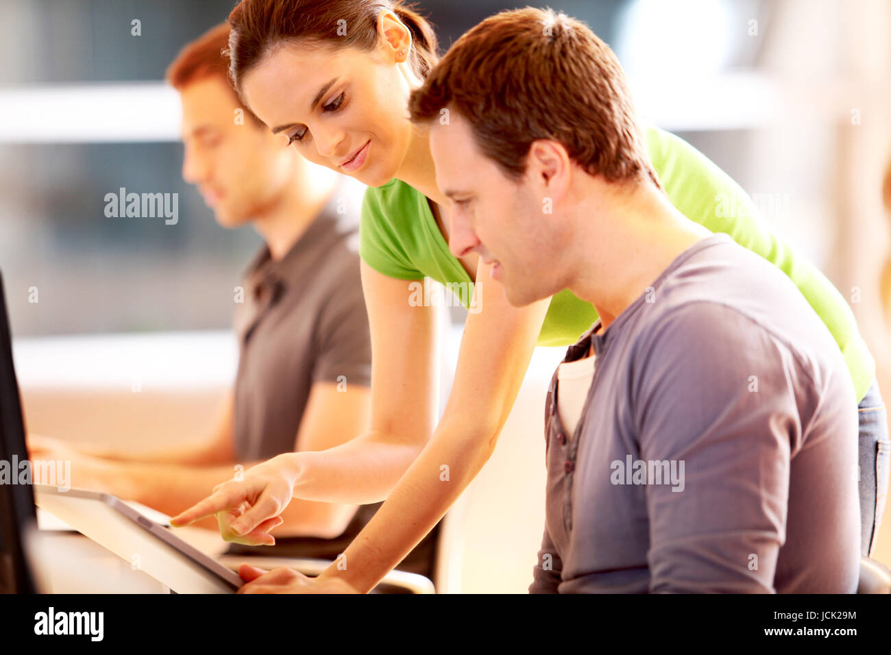Group of young people working on computer Stock Photo - Alamy