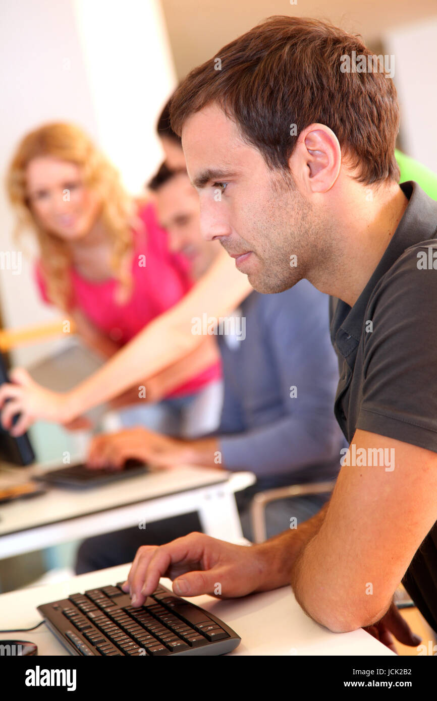 Portrait of young adult attending training class Stock Photo - Alamy
