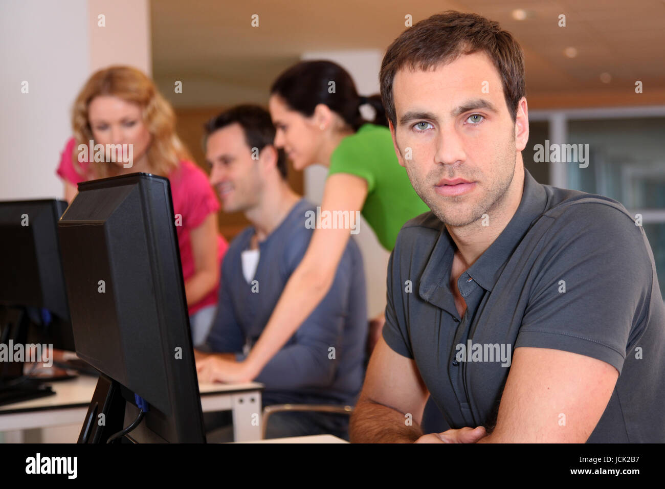 Portrait of young adult attending training class Stock Photo - Alamy