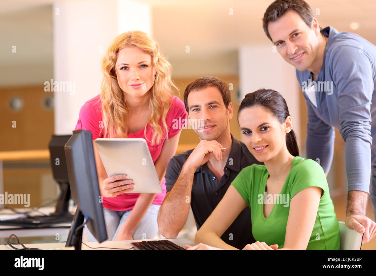 Group of smiling young people in training course Stock Photo - Alamy
