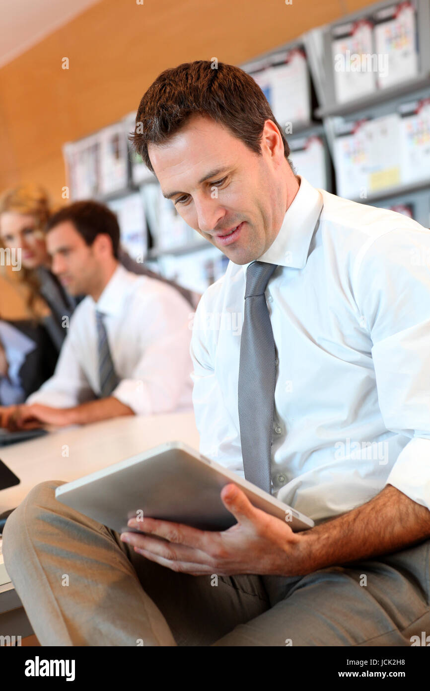Portrait of business manager using electronic tablet Stock Photo - Alamy
