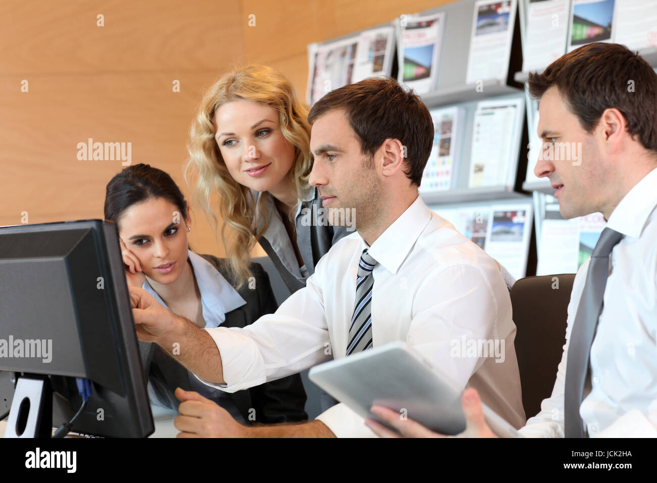 Business meeting in front of desktop computer Stock Photo - Alamy