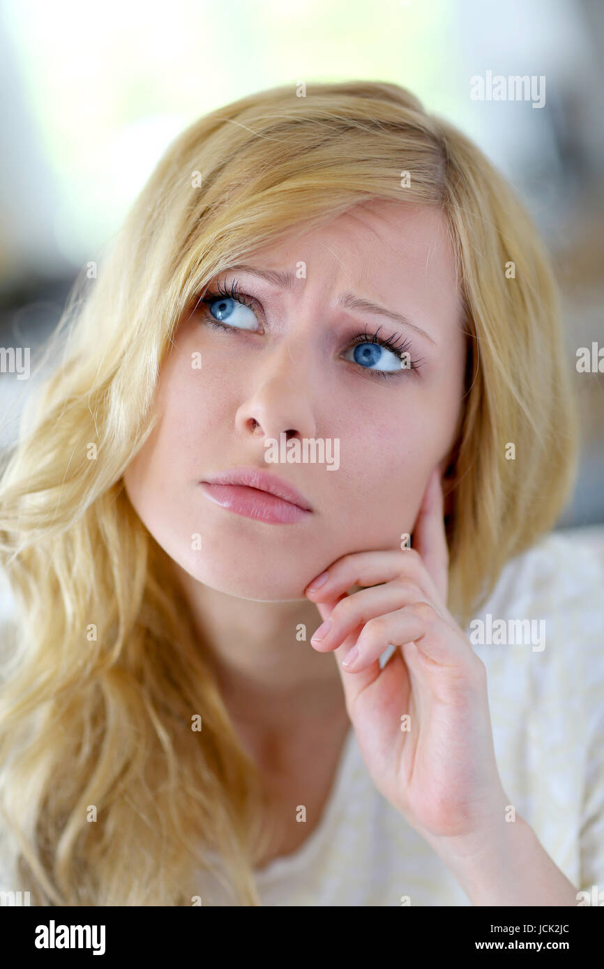 Blond woman with thoughtful look Stock Photo - Alamy