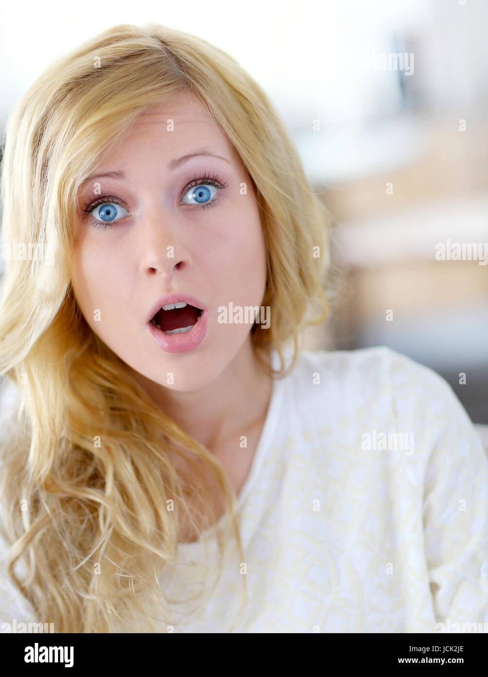 Blond woman with surprised look on her face Stock Photo - Alamy
