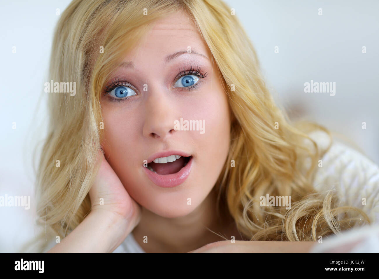 Blond woman with surprised look on her face Stock Photo - Alamy