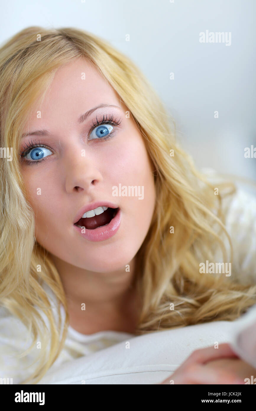 Blond woman with surprised look on her face Stock Photo - Alamy