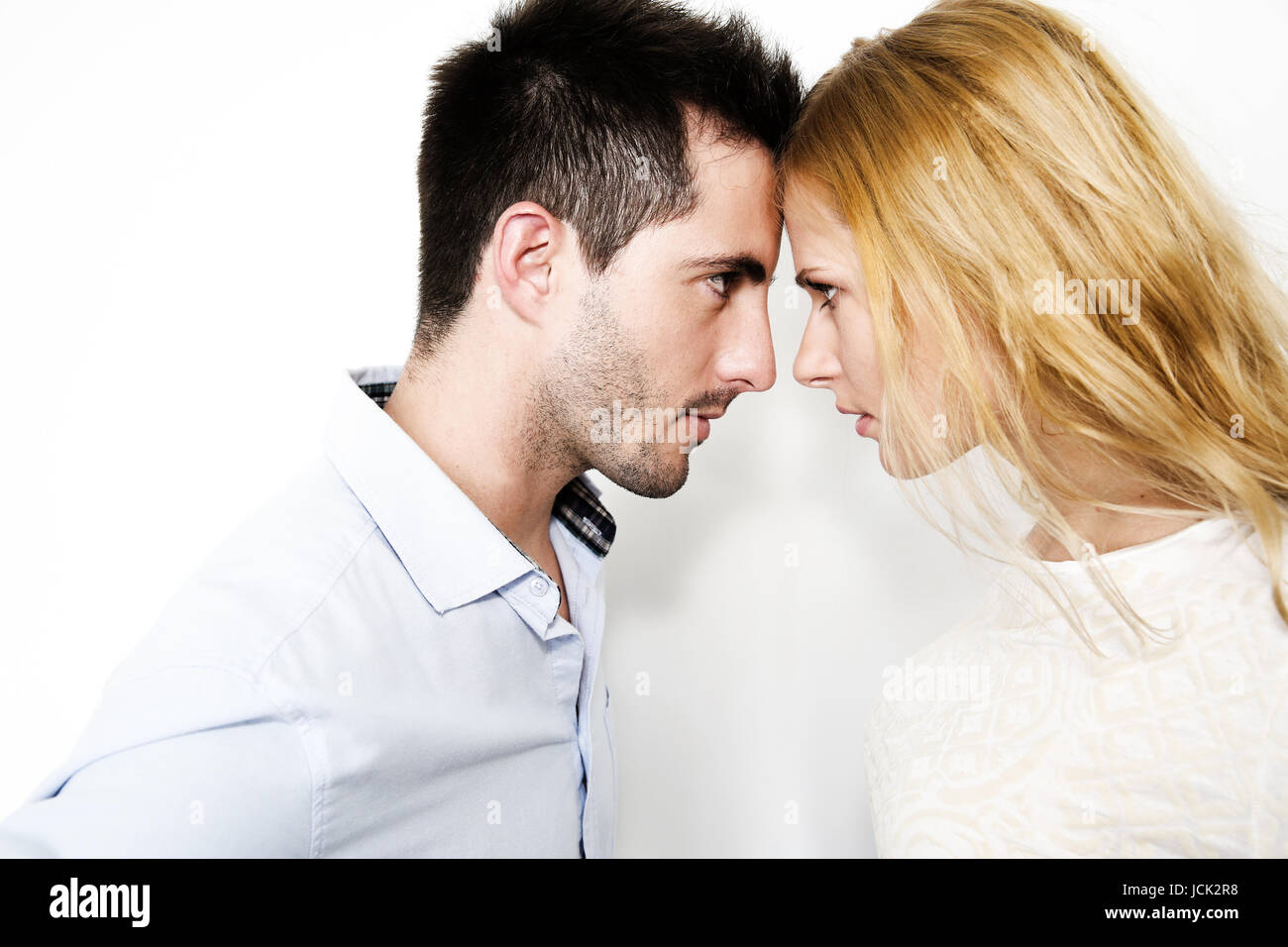 Couple on white background touching foreheads Stock Photo - Alamy