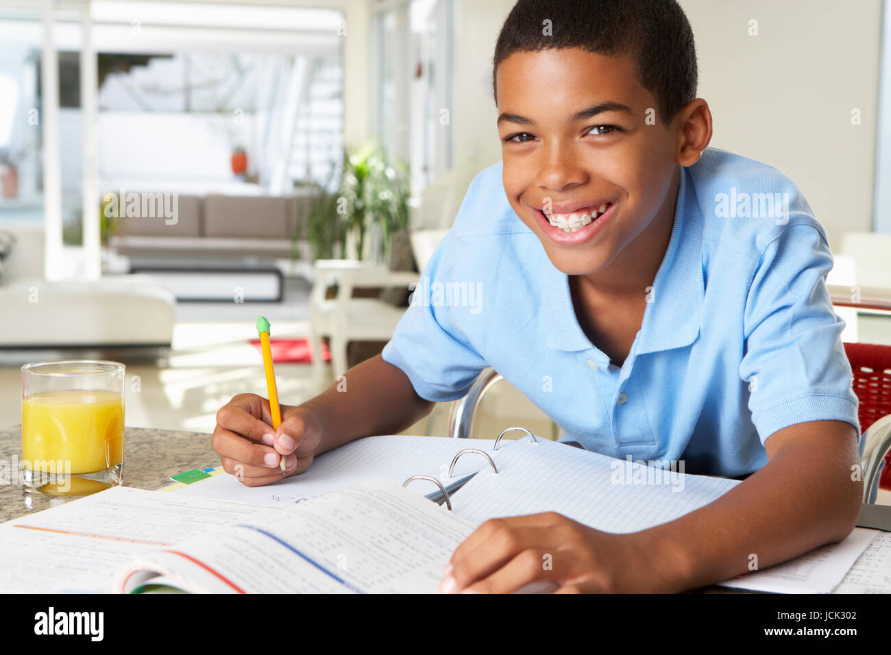 Boy Doing Homework In Kitchen Stock Photo - Alamy