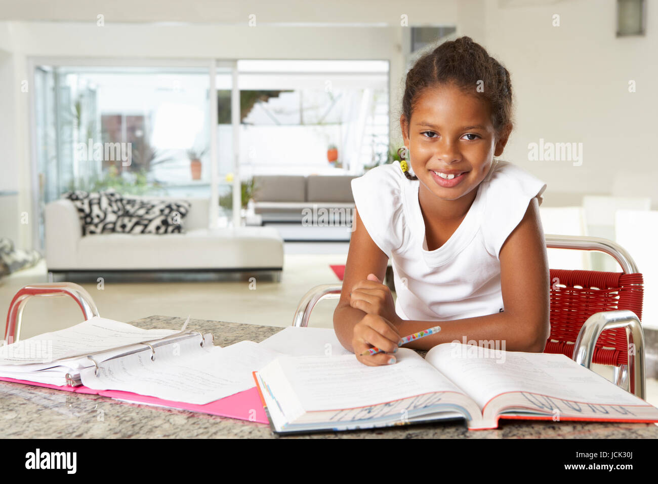 Girl Doing Homework In Kitchen Stock Photo - Alamy