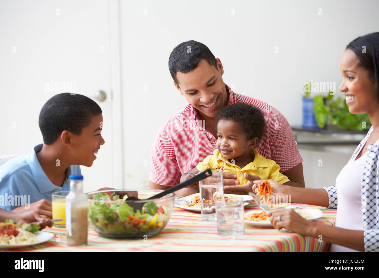 Family Eating Meal Together At Home Stock Photo - Alamy