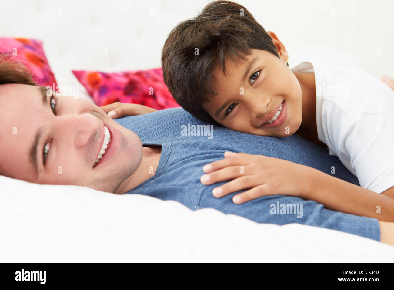 Father And Son Lying In Bed Together Stock Photo - Alamy