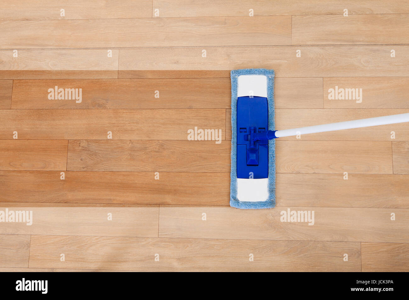 Overhead view of a modern sponge style mop being used for cleaning a ...