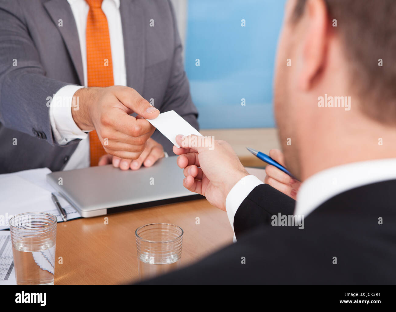 Two businessmen exchanging business card hi-res stock photography and ...