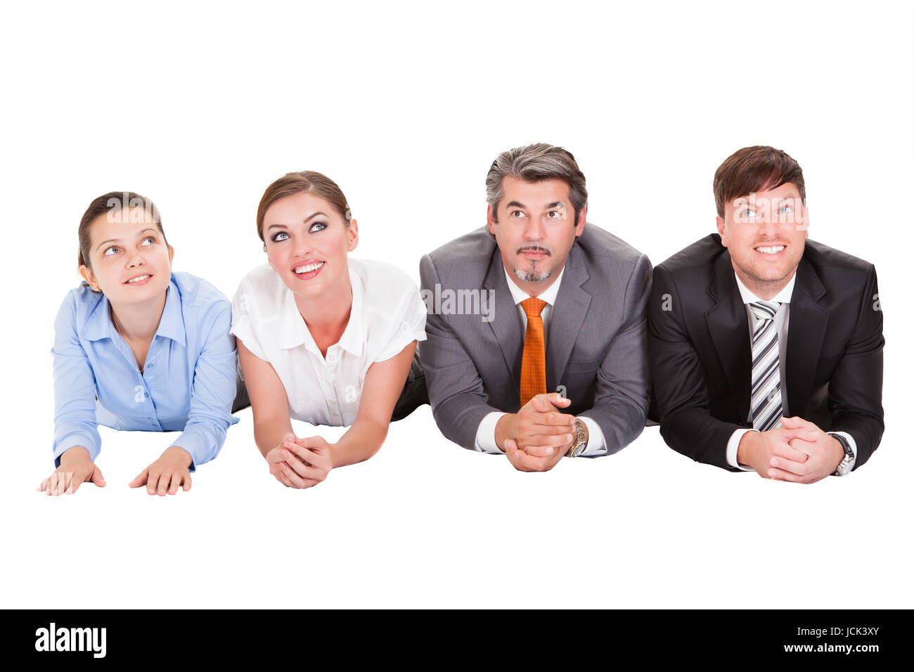 Group Of Happy Businesspeople Lying On Front In A Row Over White ...