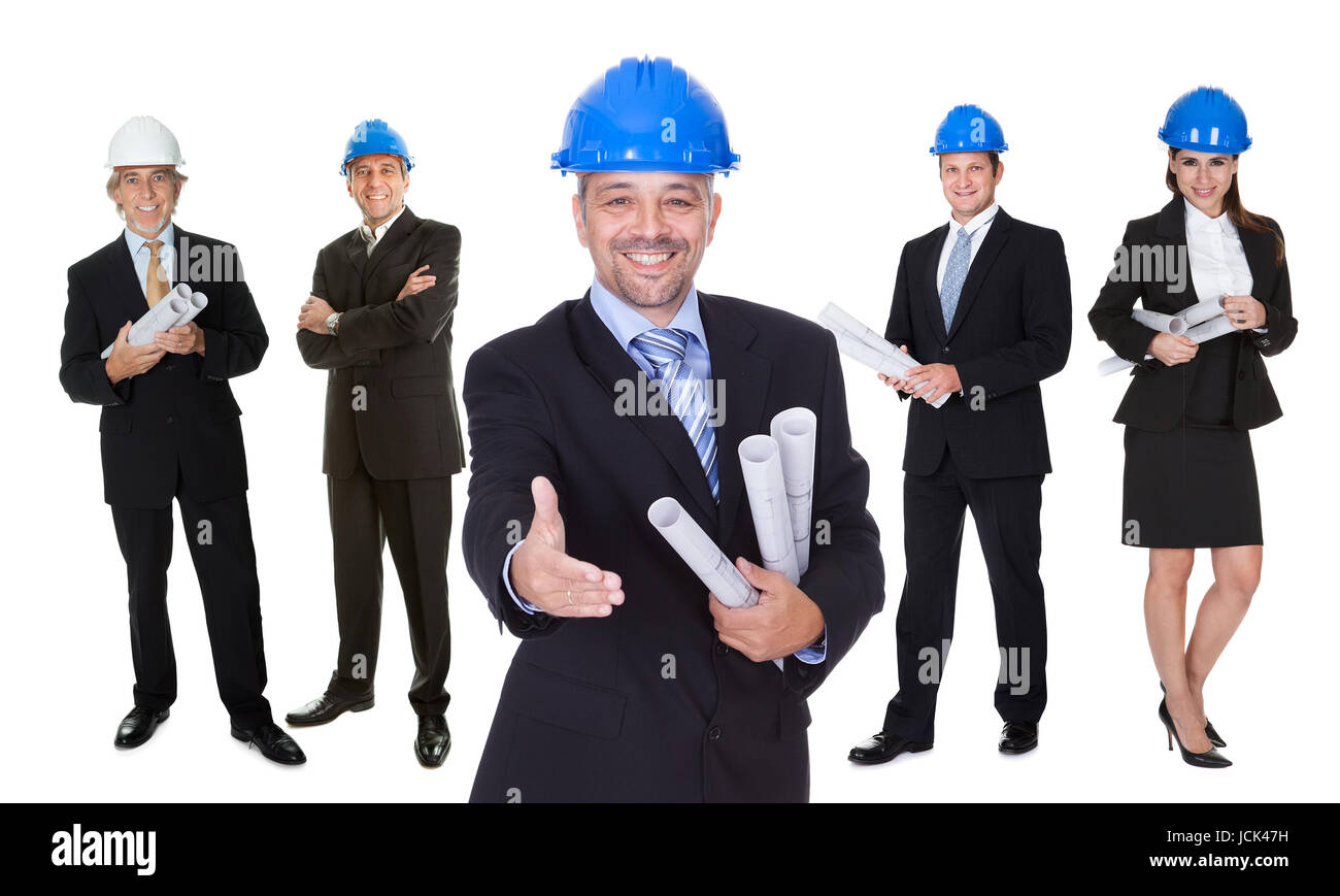 Portrait of happy architect offering handshake and his team. Isolated ...