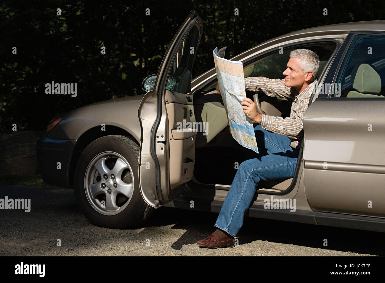 Man looking at map Stock Photo - Alamy