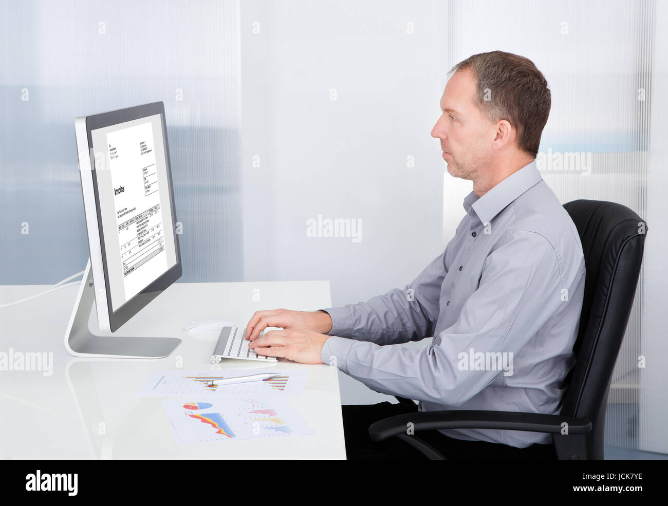 Portrait Of A Businessman Using Computer At Office Desk Stock Photo - Alamy