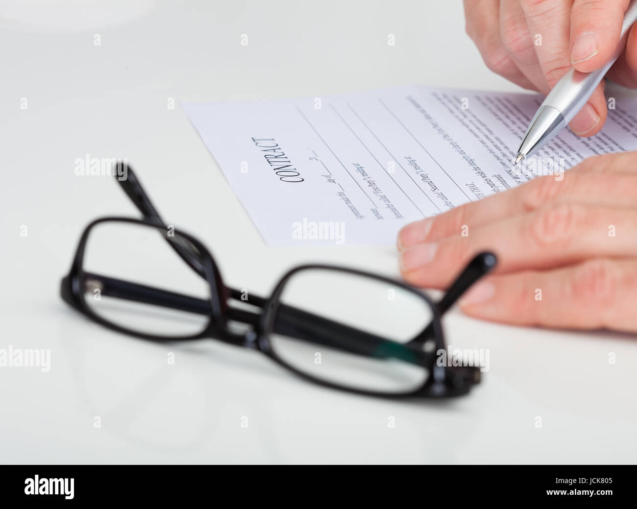 Close-up Of A Businessman Reading Contract Paper Stock Photo - Alamy