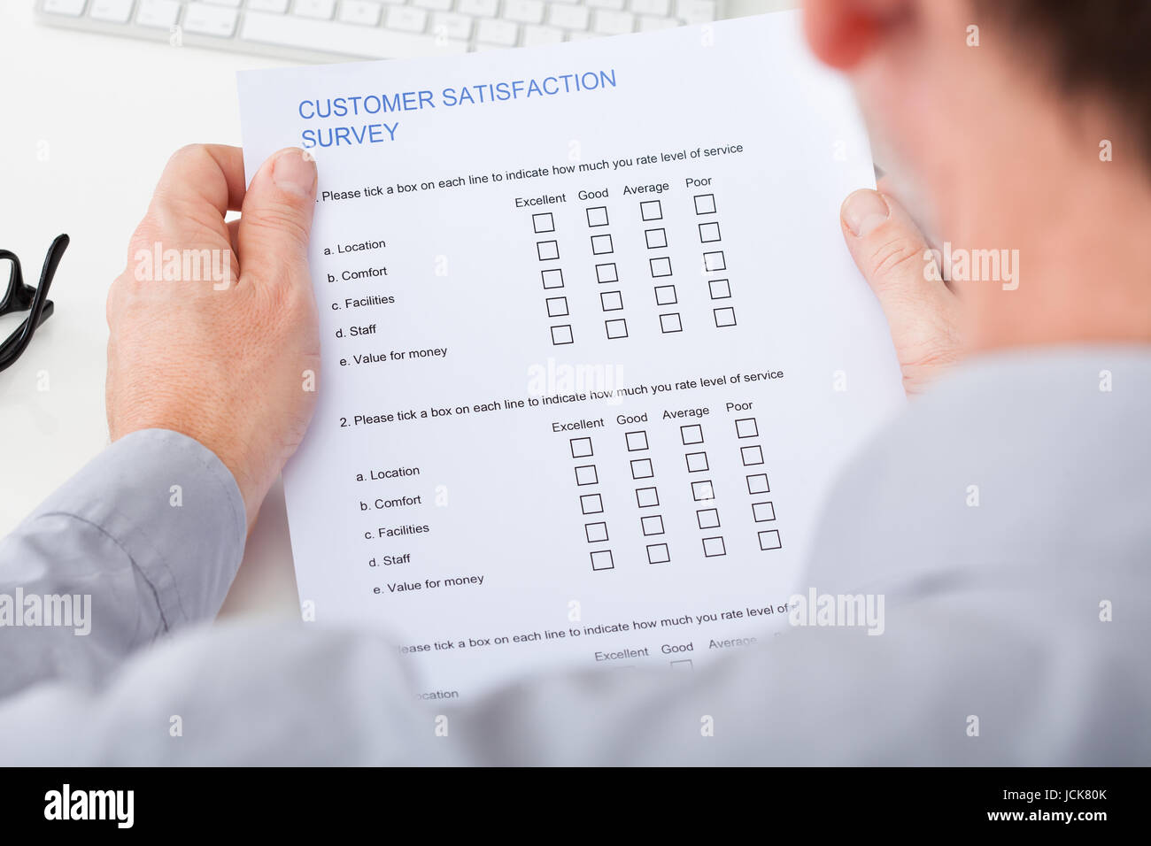 Close-up Of Man's Hand Filling Customer Survey Form Stock Photo - Alamy