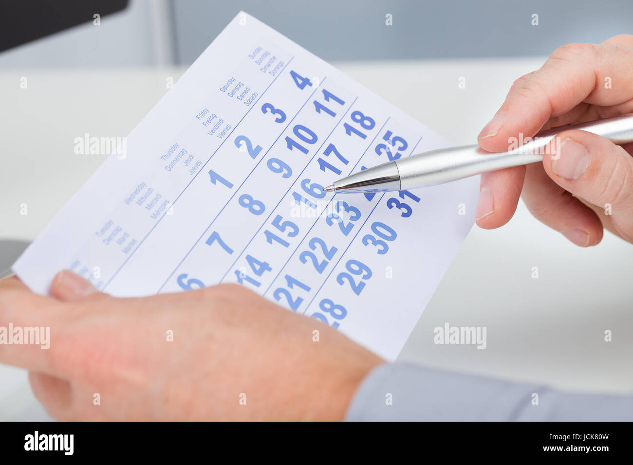 Close-up Of Man Marking With Pen And Looking At Date On Calendar Stock ...