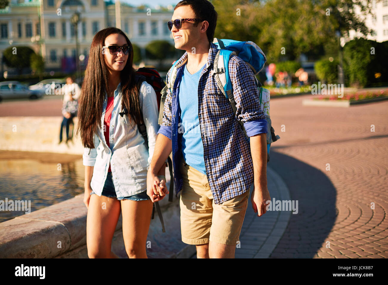 Amorous dates with backpacks taking walk in a city Stock Photo - Alamy