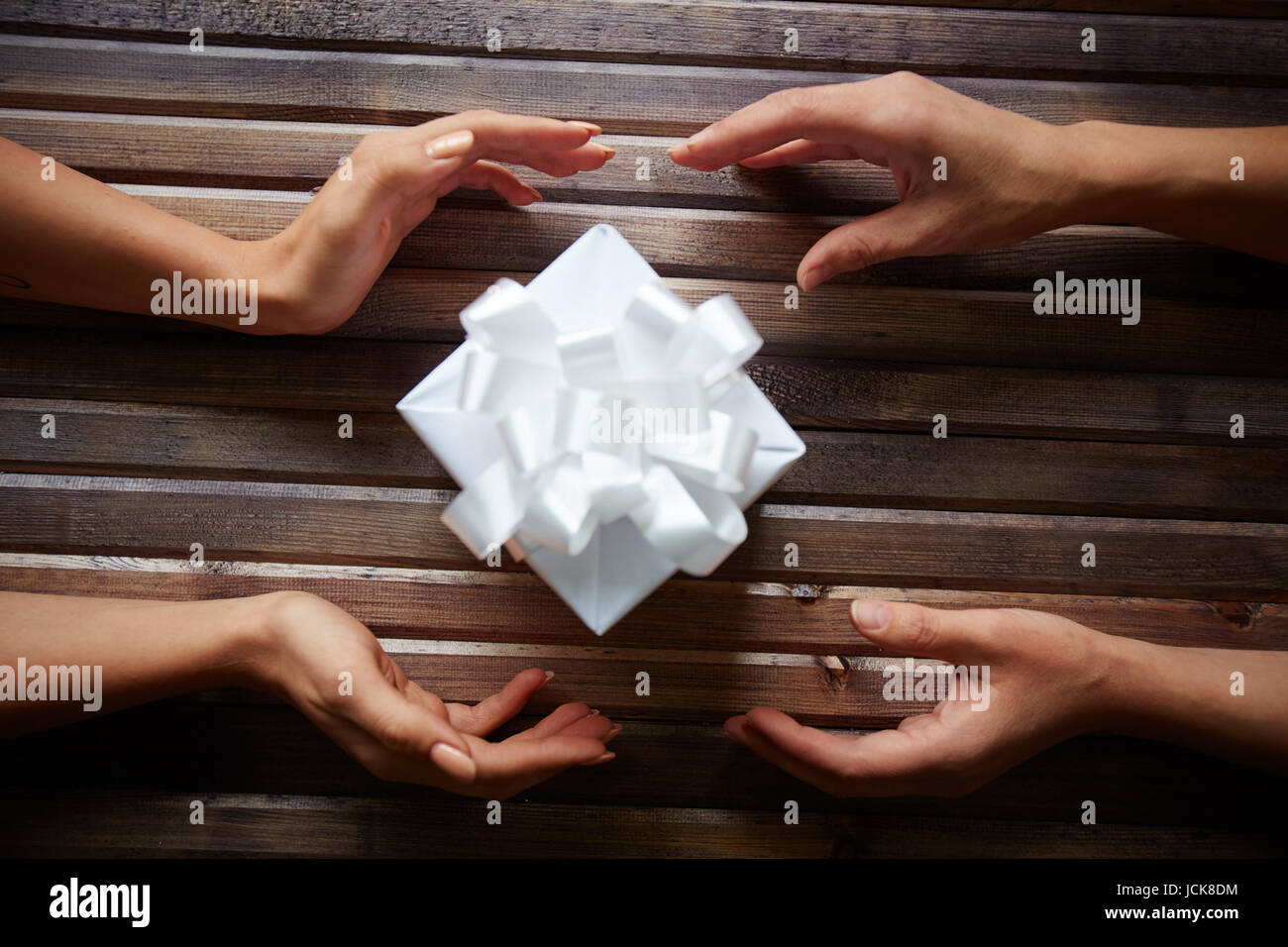 Hands of woman giving box with Christmas present to her friend on ...