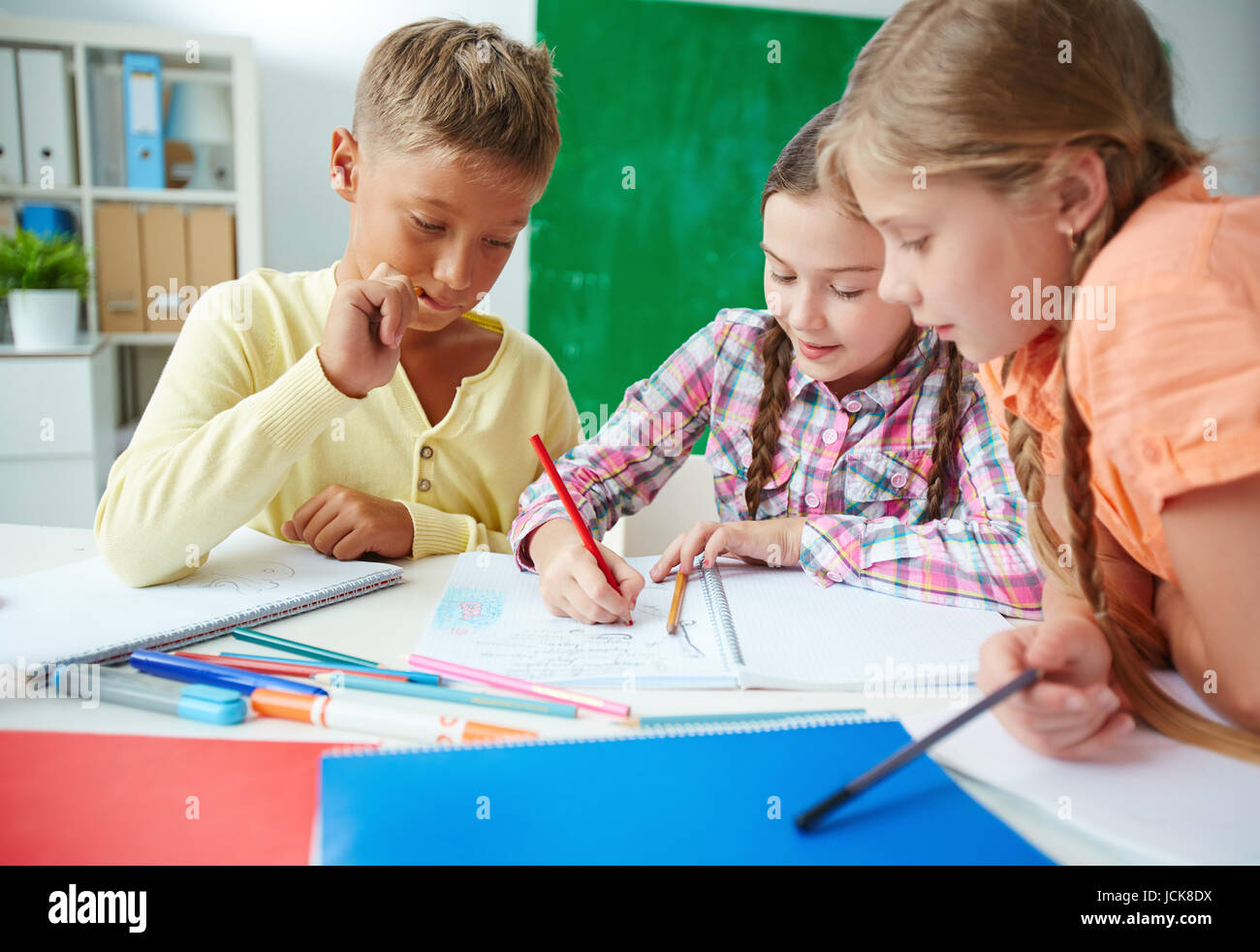 Group of pupils drawing together at lesson in junior school Stock Photo ...