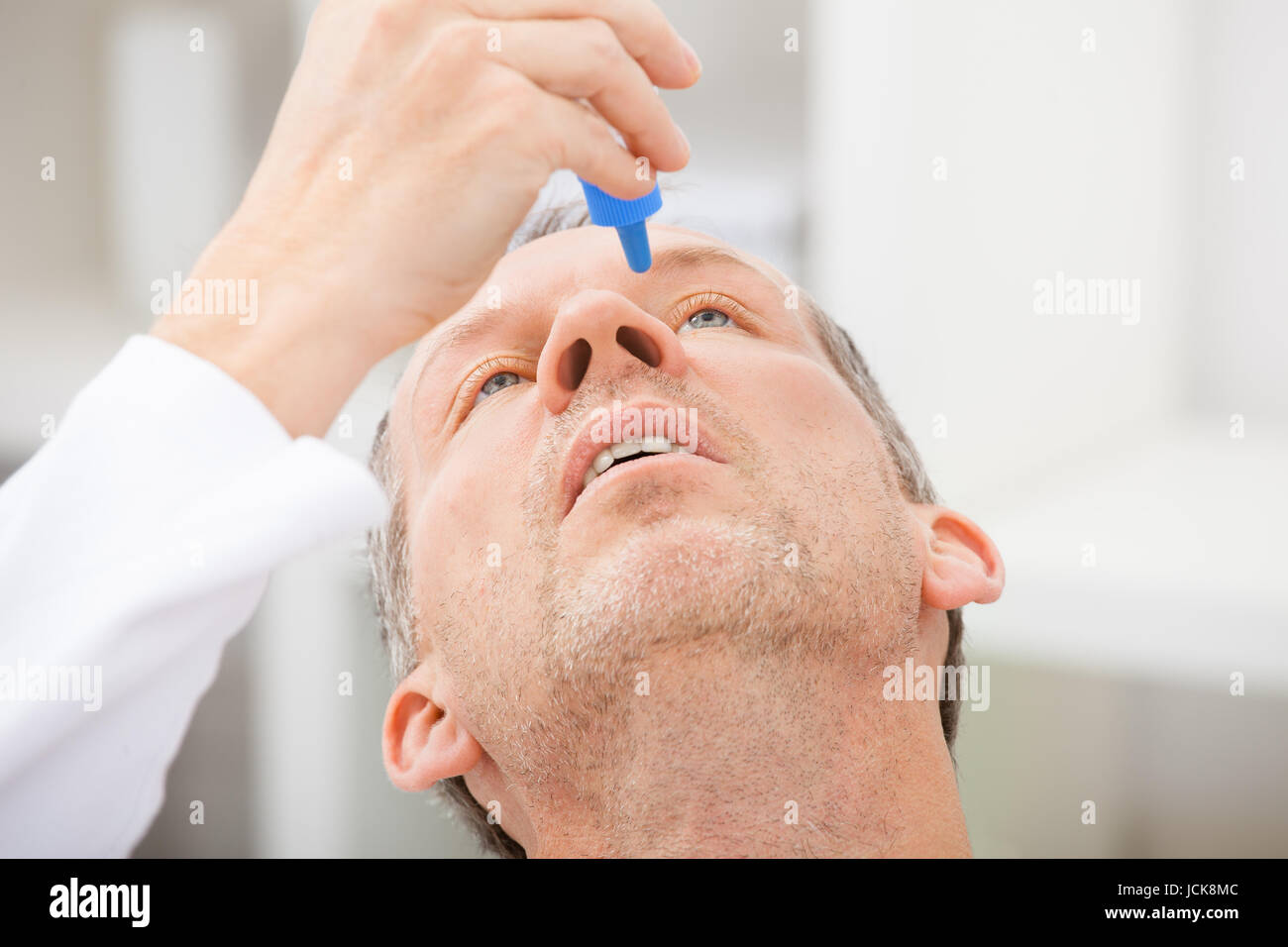 Putting eye drops in eyes hi-res stock photography and images - Alamy