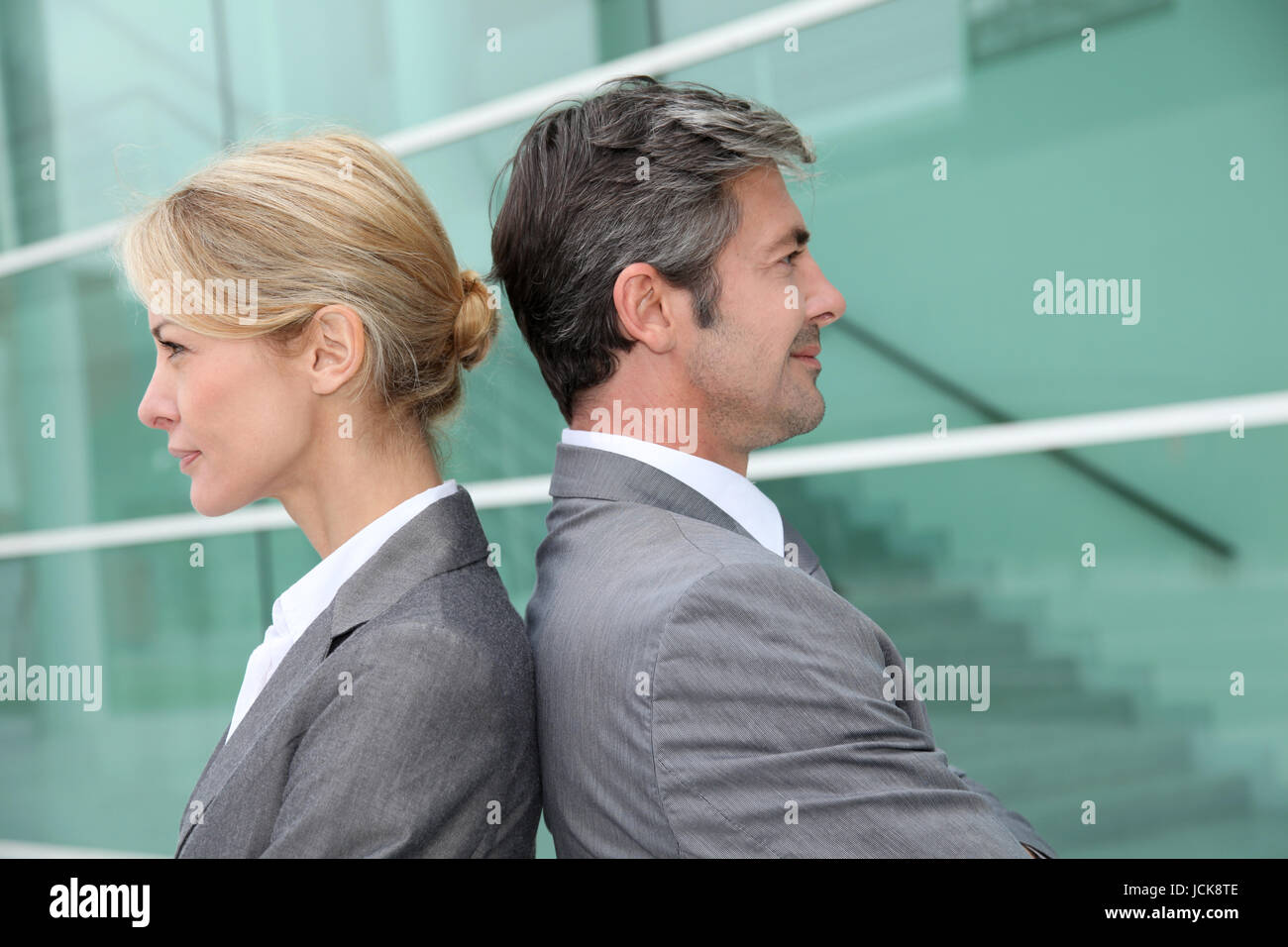 Business people standing back to back Stock Photo - Alamy