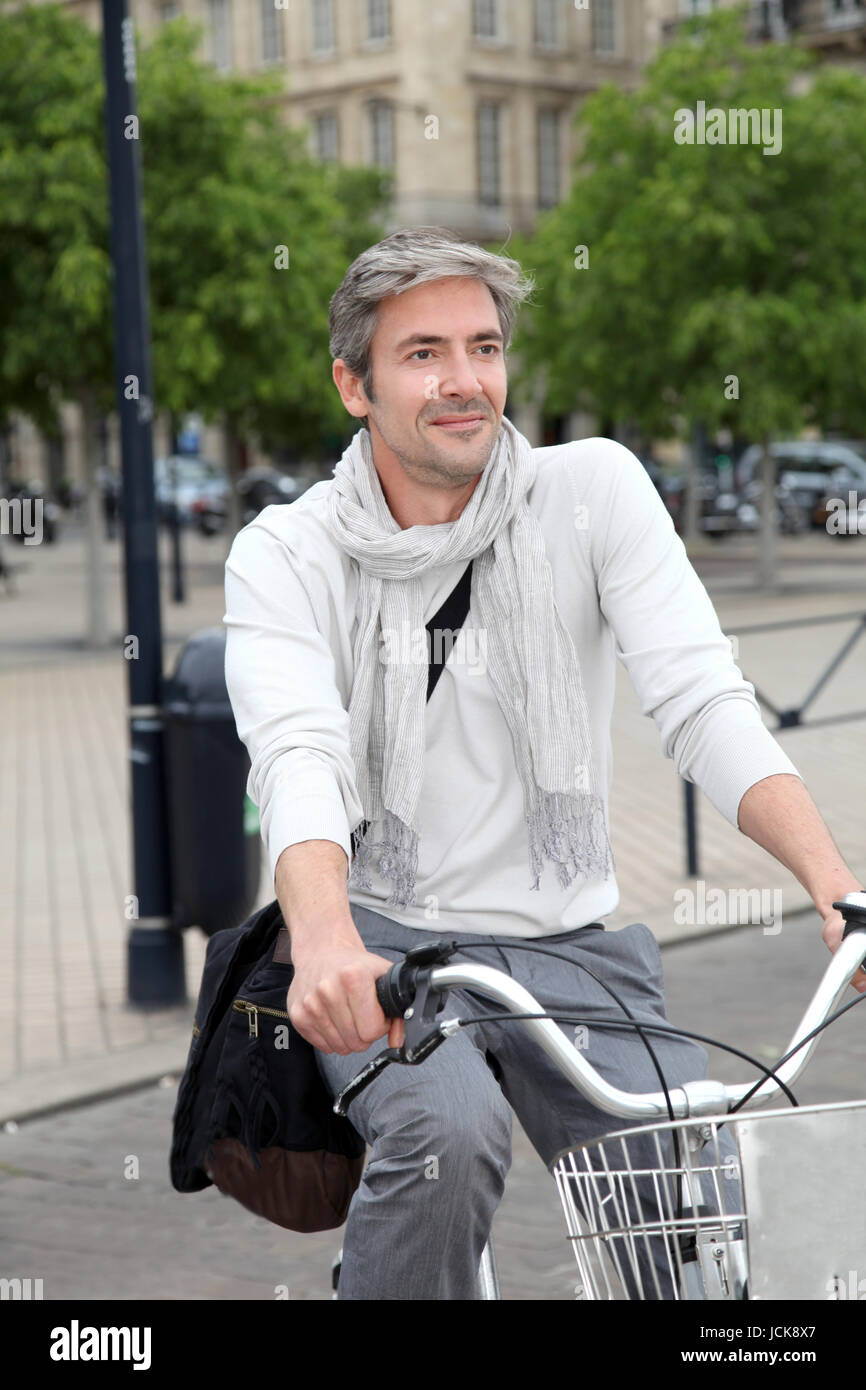 Trendy guy riding bike in town Stock Photo - Alamy