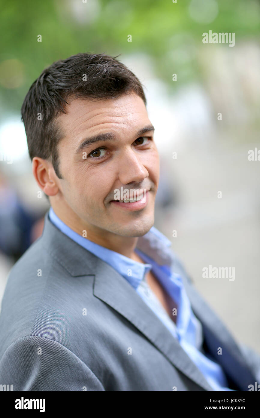 Portrait of handsome man with jacket standing in the street Stock Photo ...