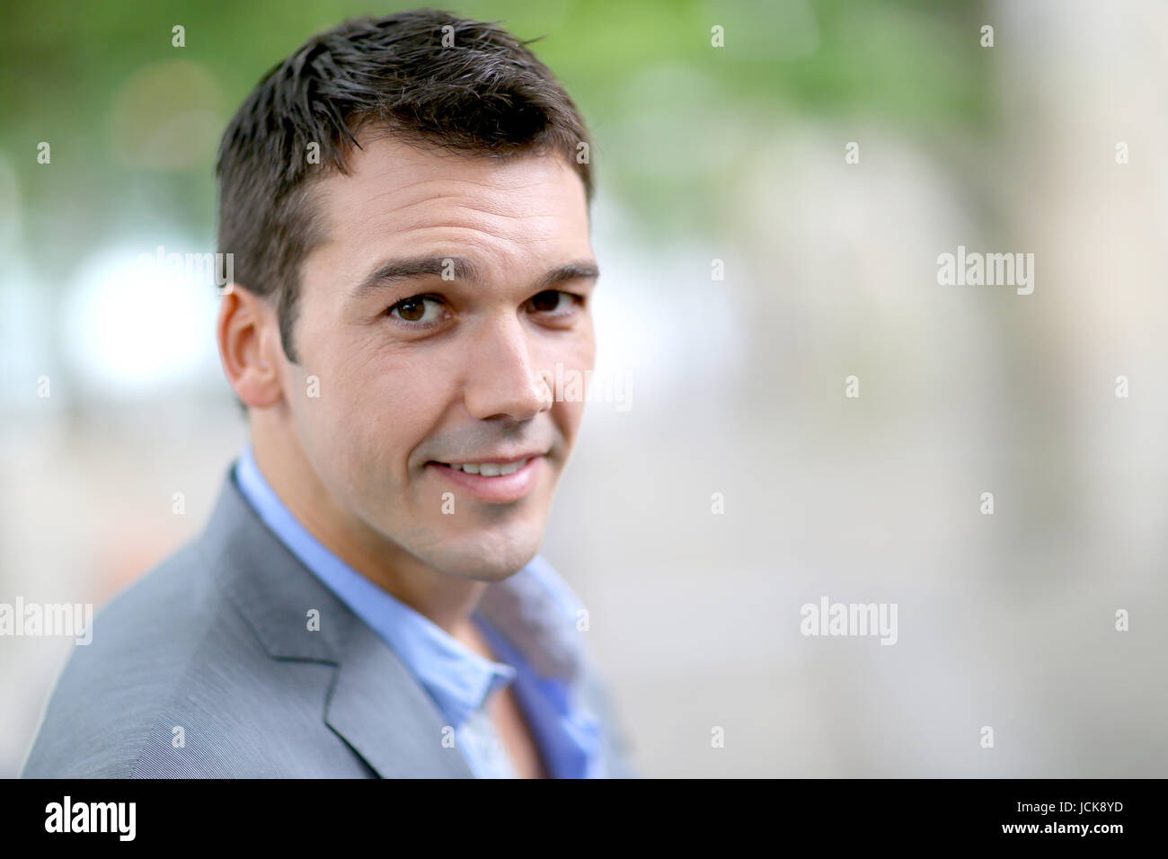 Portrait of handsome man with jacket standing in the street Stock Photo ...
