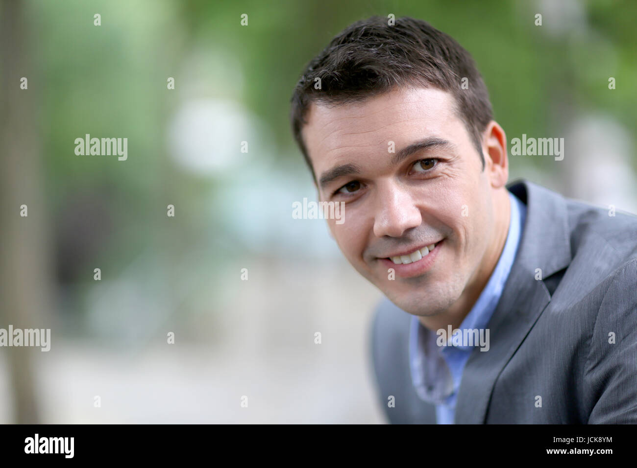 Portrait of handsome man with jacket standing in the street Stock Photo ...