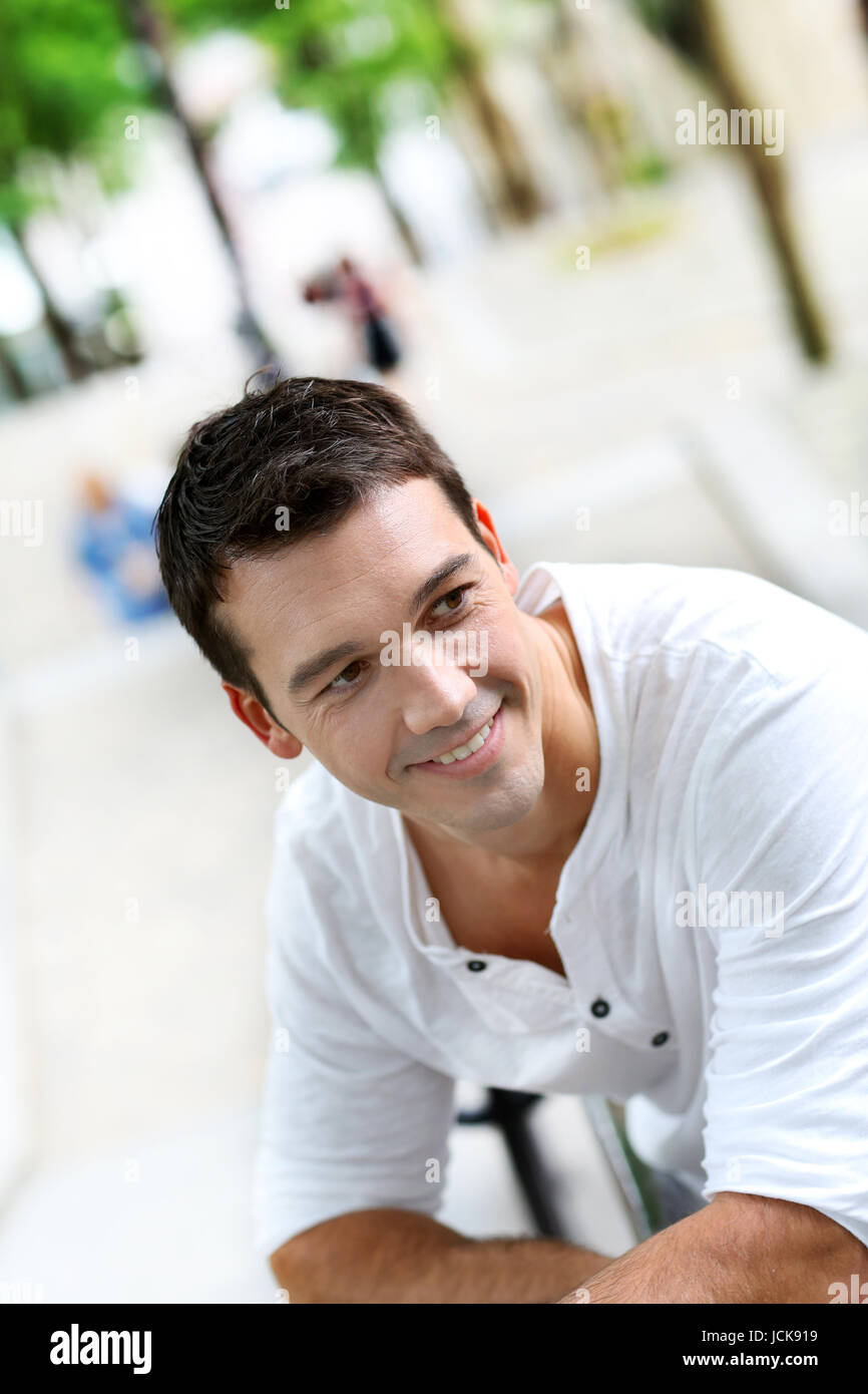 Portrait of smiling man standing in the street Stock Photo - Alamy