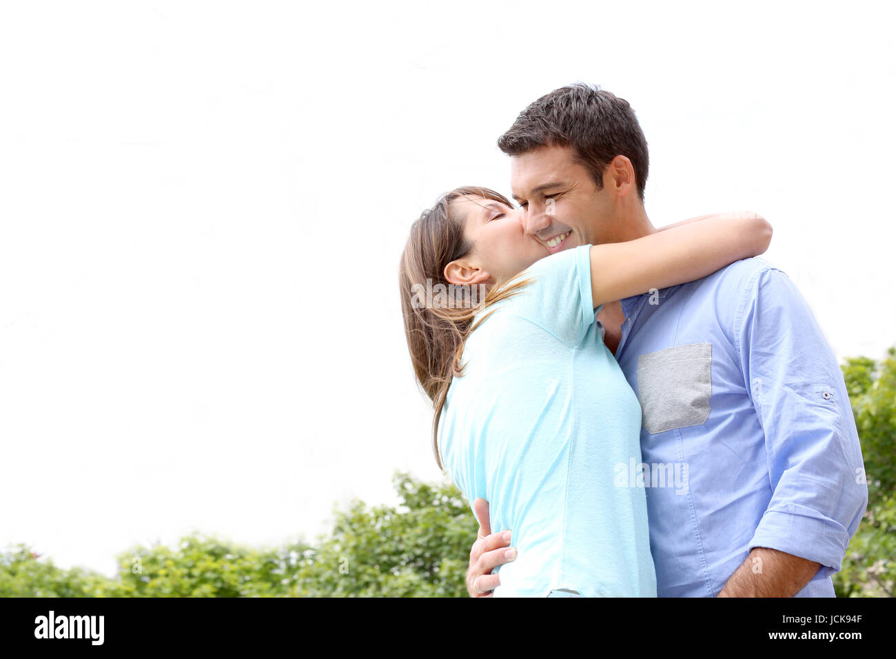 Girl kissing boyfriend on a date Stock Photo - Alamy