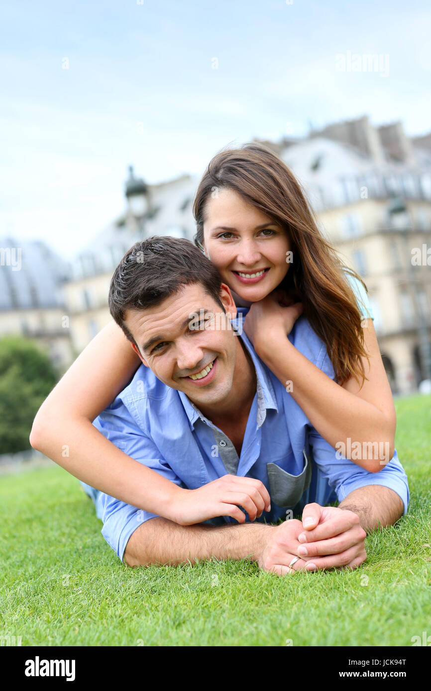 In love couple laying in public park Stock Photo - Alamy