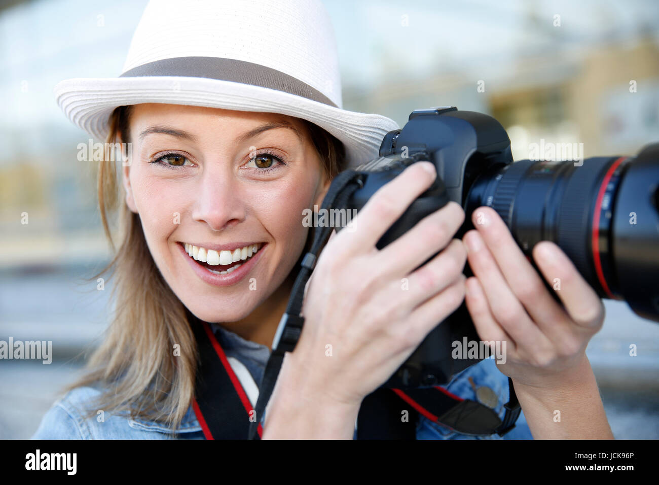 Beautiful woman photographer holding photo camera Stock Photo - Alamy