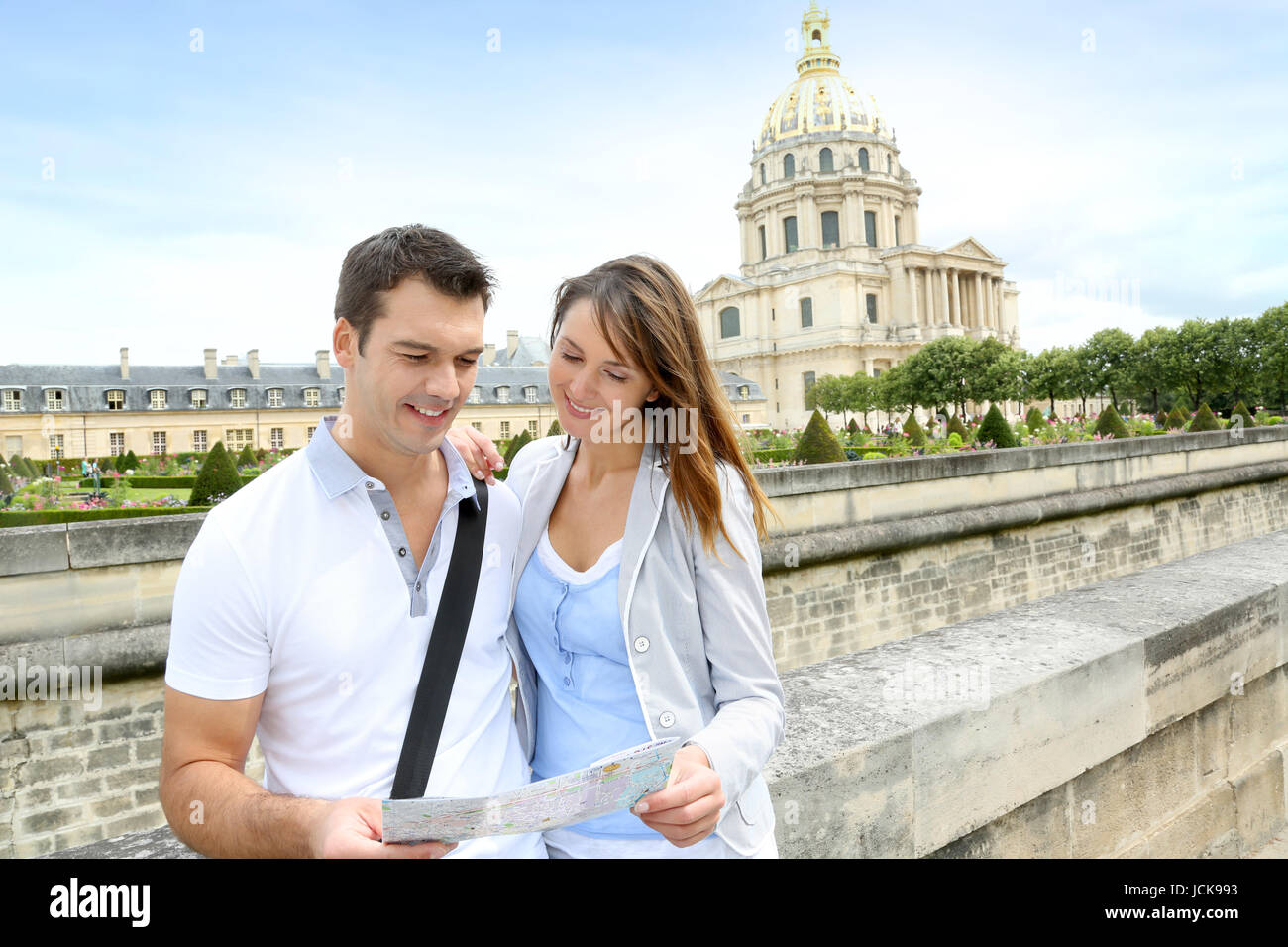 Couple reading tourist map in front of the Invalides building Stock ...