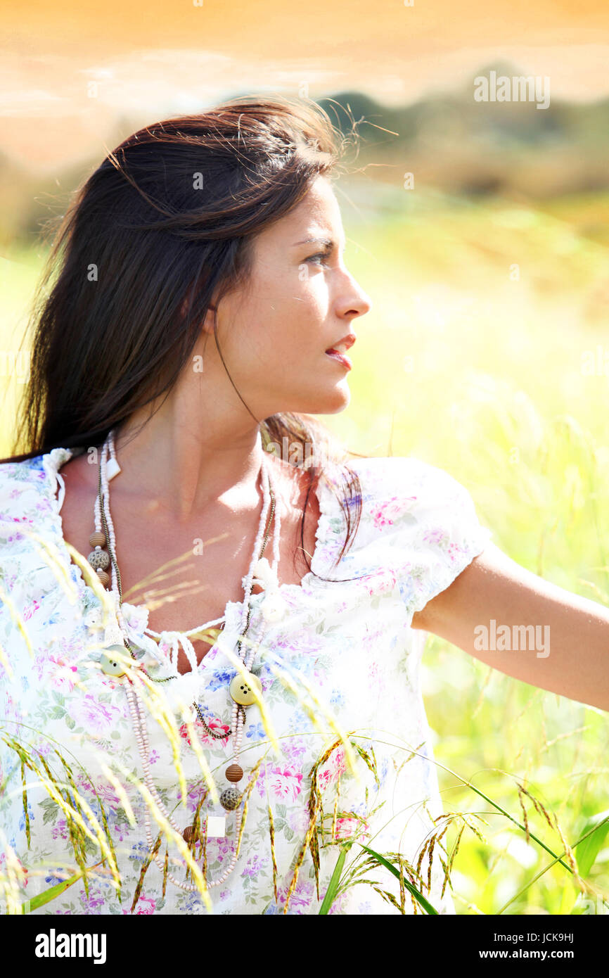 Beautiful woman in country field Stock Photo - Alamy