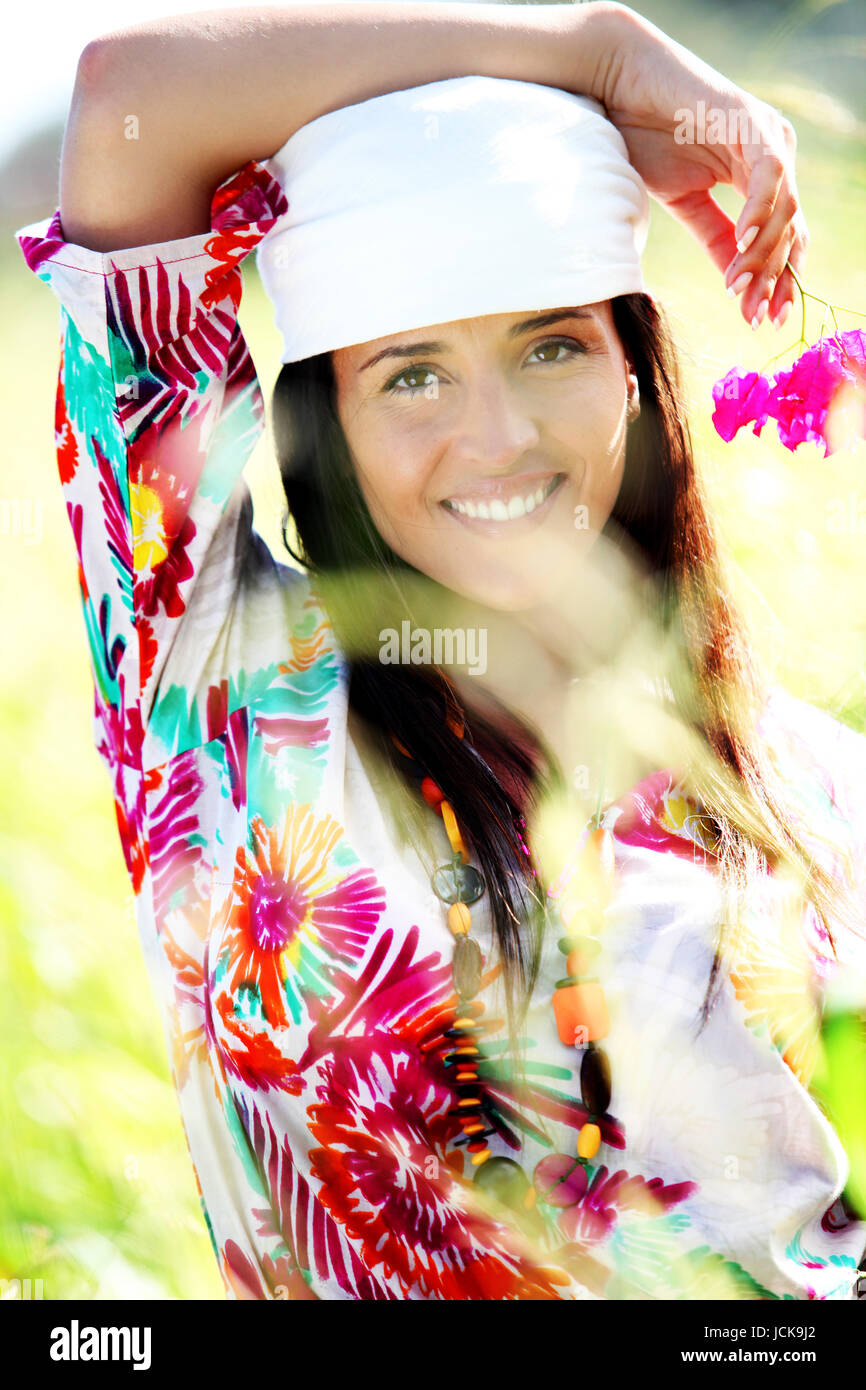 Beautiful gypsy girl with scarf standing in meadow Stock Photo - Alamy