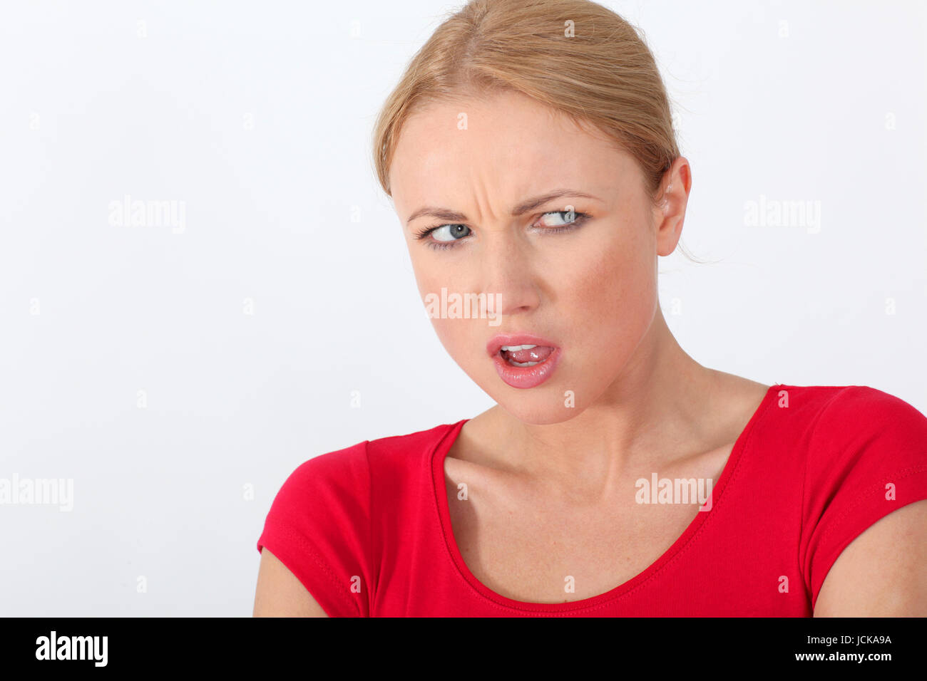 Woman in red shirt with angry look Stock Photo - Alamy