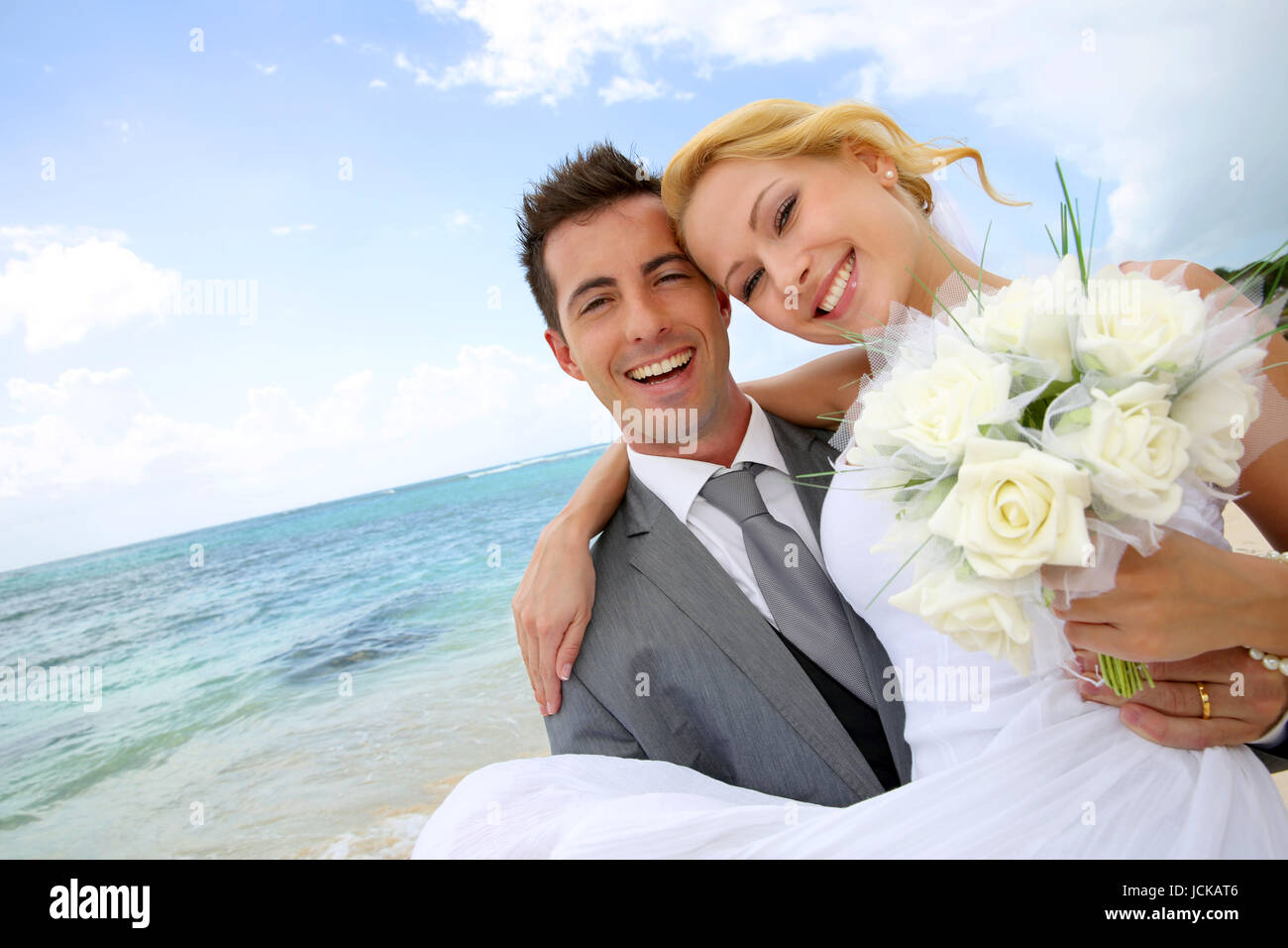 Groom carrying bride in arms hi-res stock photography and images - Alamy
