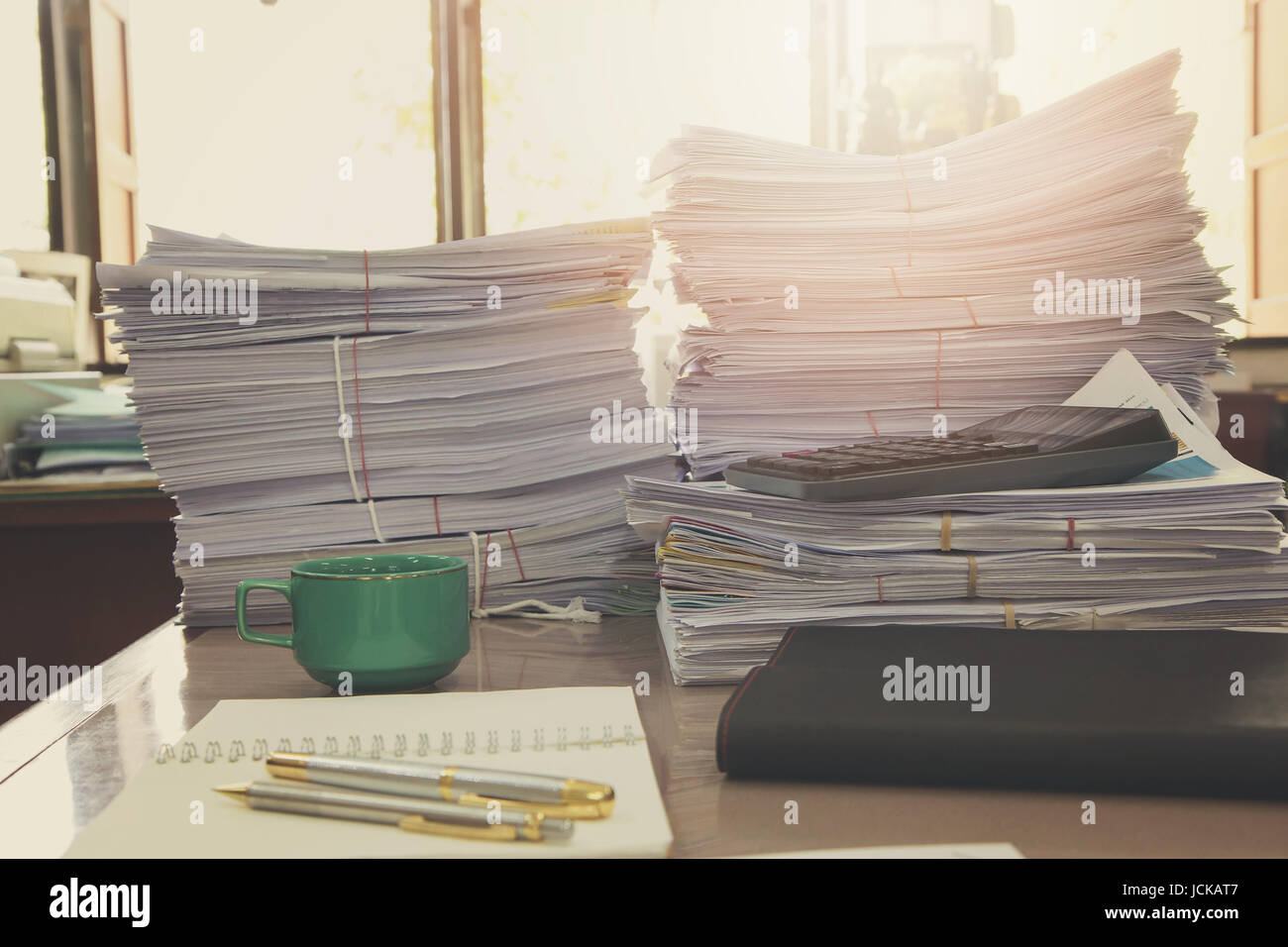 Pile of unfinished documents on office desk, Stack of business paper ...