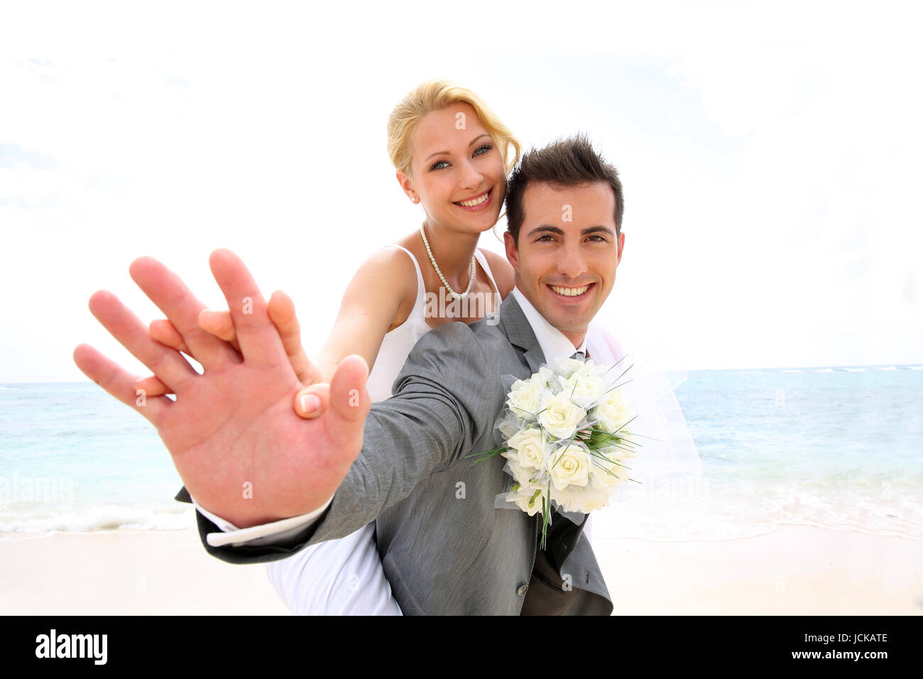 Groom giving piggyback ride to his bride Stock Photo - Alamy