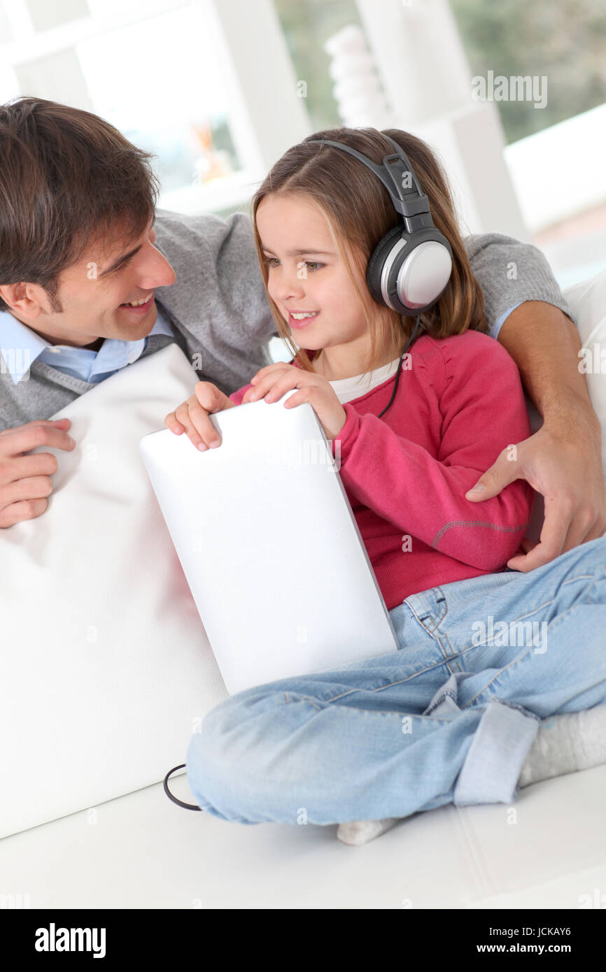 Father and daughter listening to music Stock Photo - Alamy